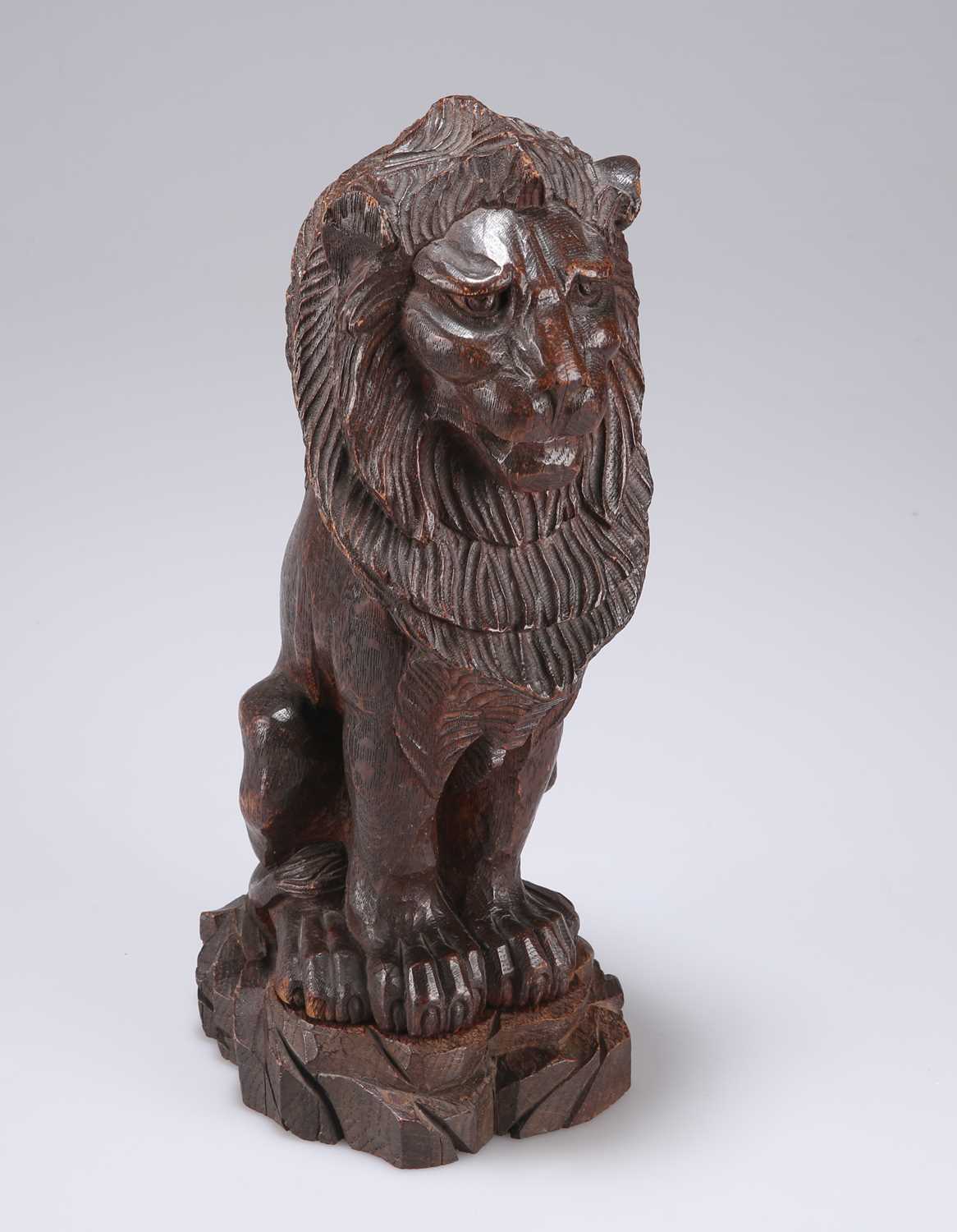 Lot 62 - A LATE VICTORIAN OAK MODEL OF A LION