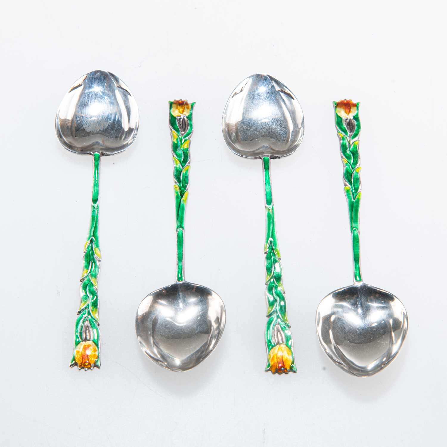 Lot 1195 - A SET OF FOUR ART DECO SILVER AND ENAMEL