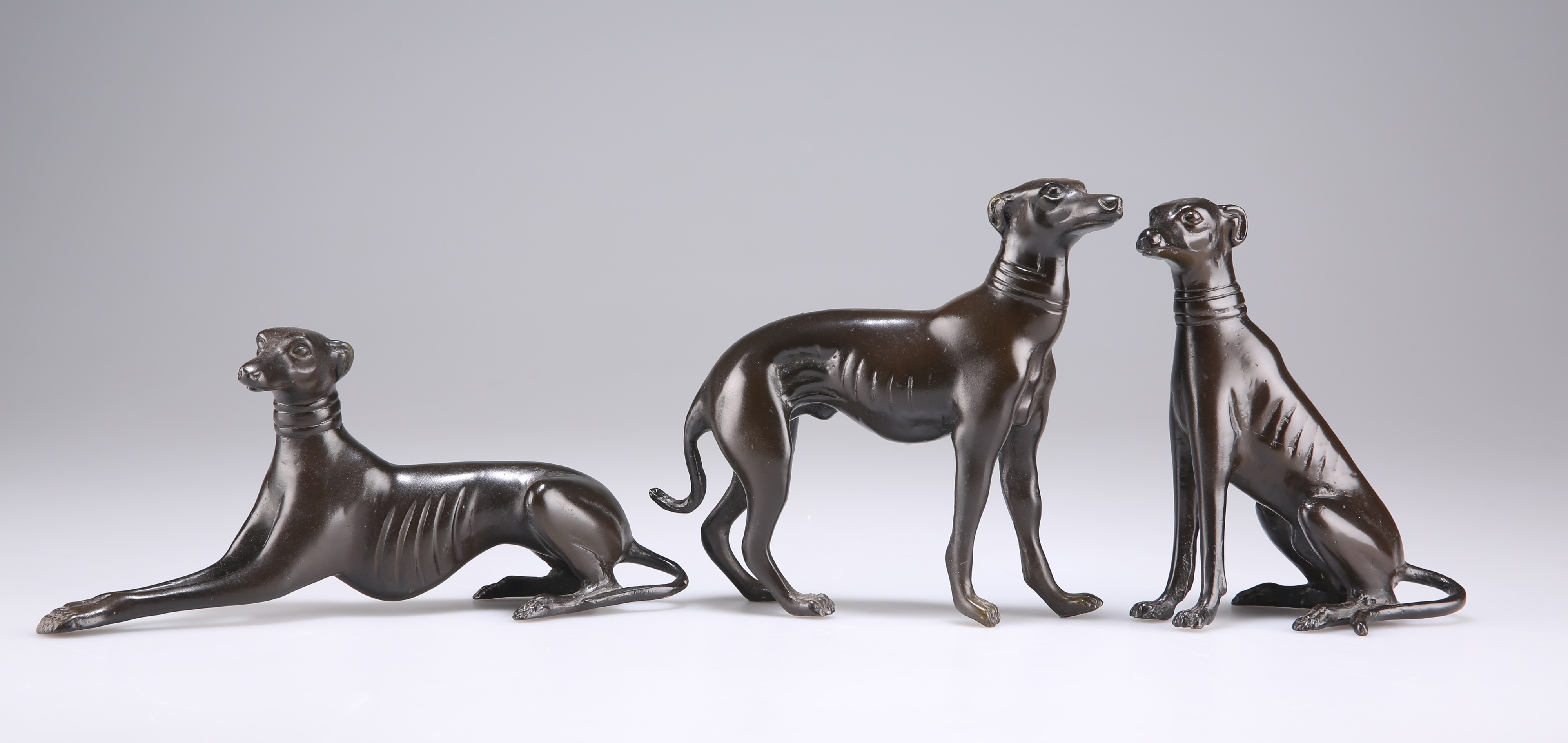 Lot 293 - THREE BRONZE MODELS OF GREYHOUNDS