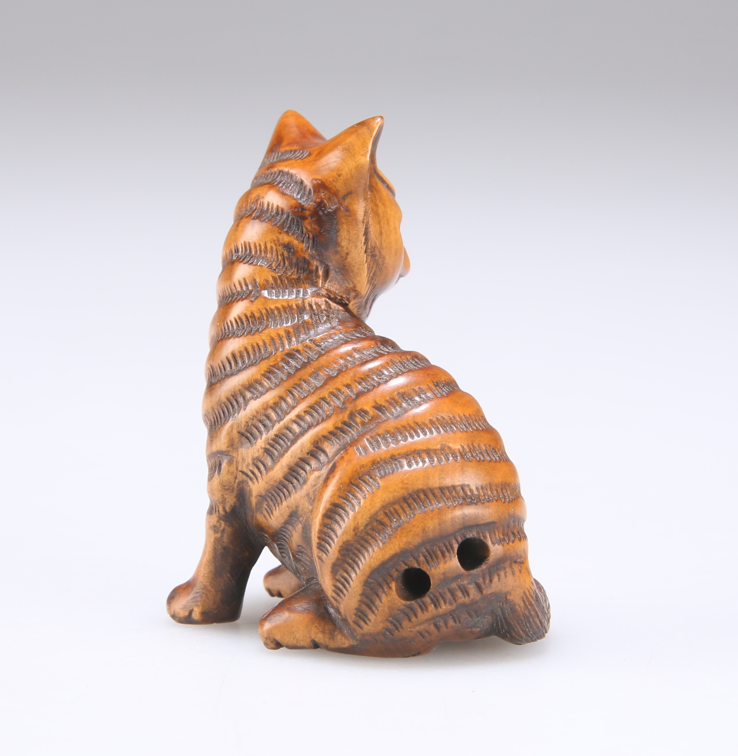 Lot 633 - A JAPANESE CARVED WOOD CAT NETSUKE