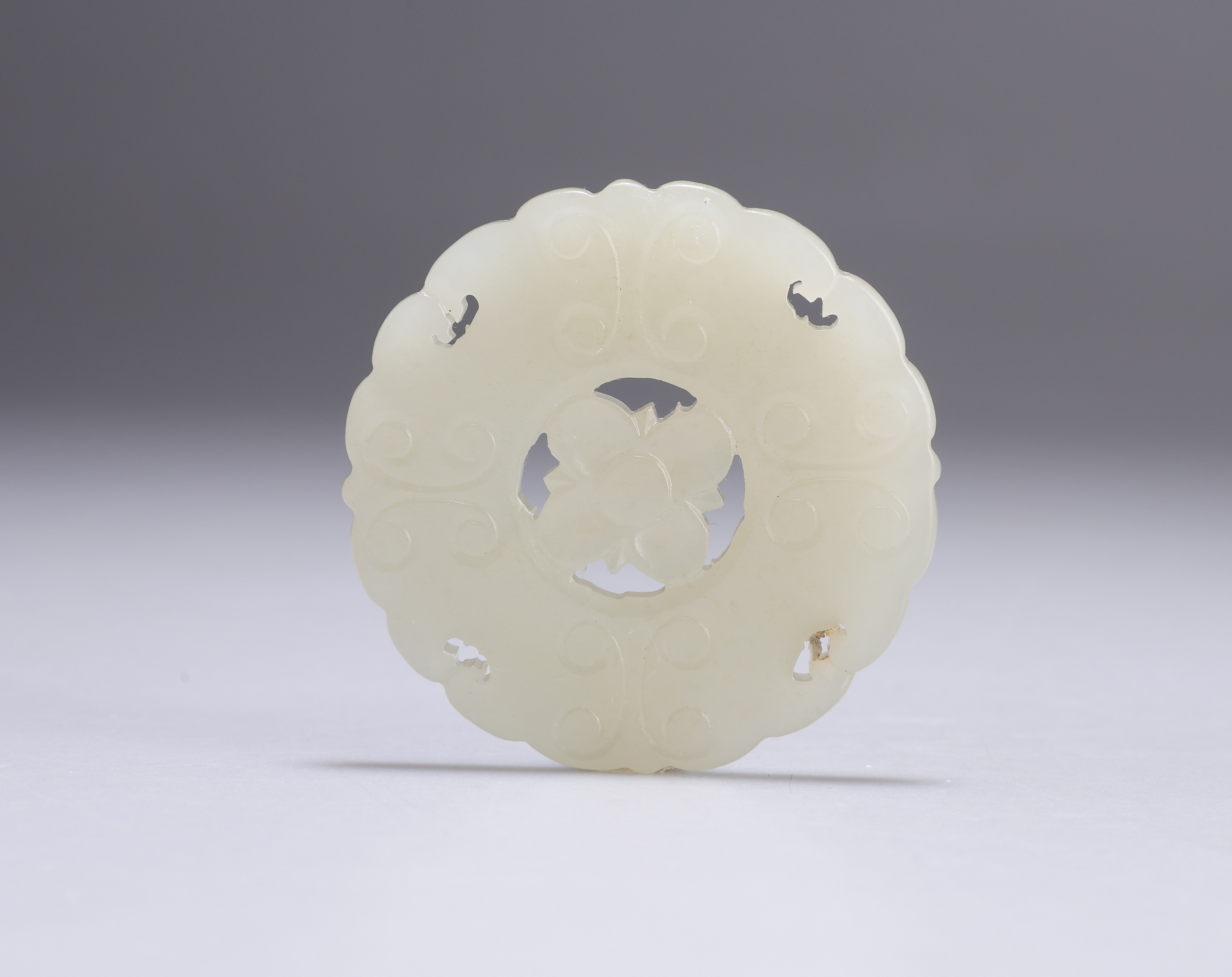 Lot 657 - A CHINESE JADE BI DISC